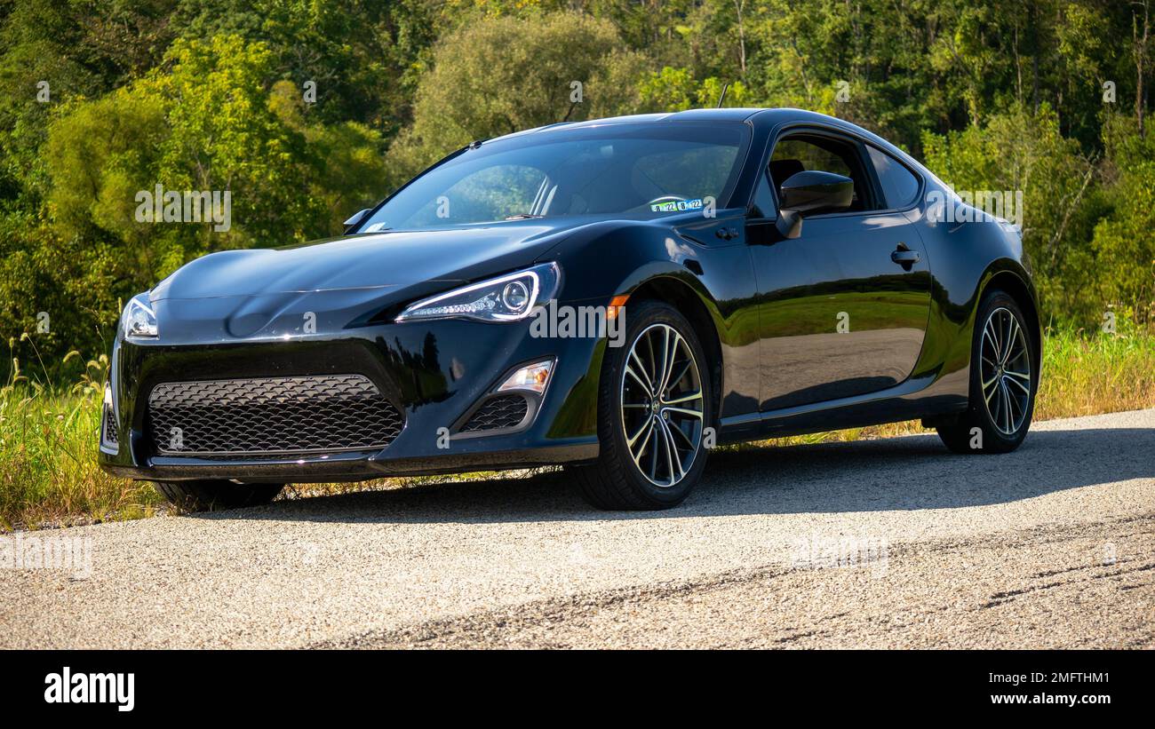 A jet-black two-door Scion car on the road Stock Photo - Alamy
