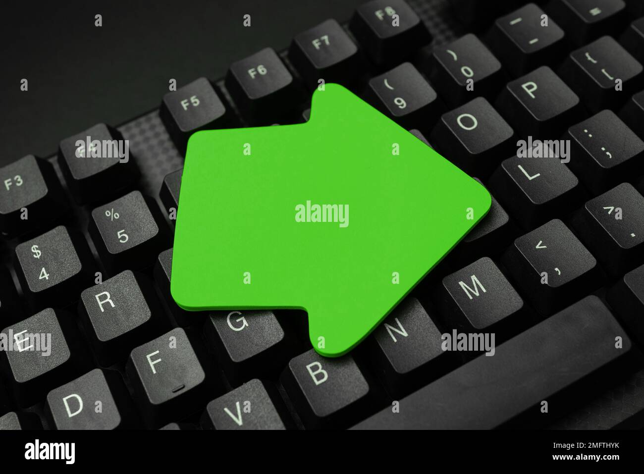 Sticker lying on black keyboard. Important message written over paper ...