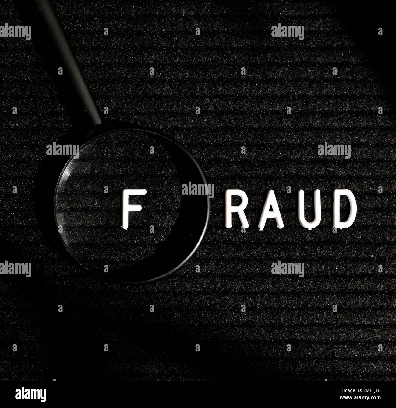 fraud word with letter magnifying glass top view Stock Photo - Alamy
