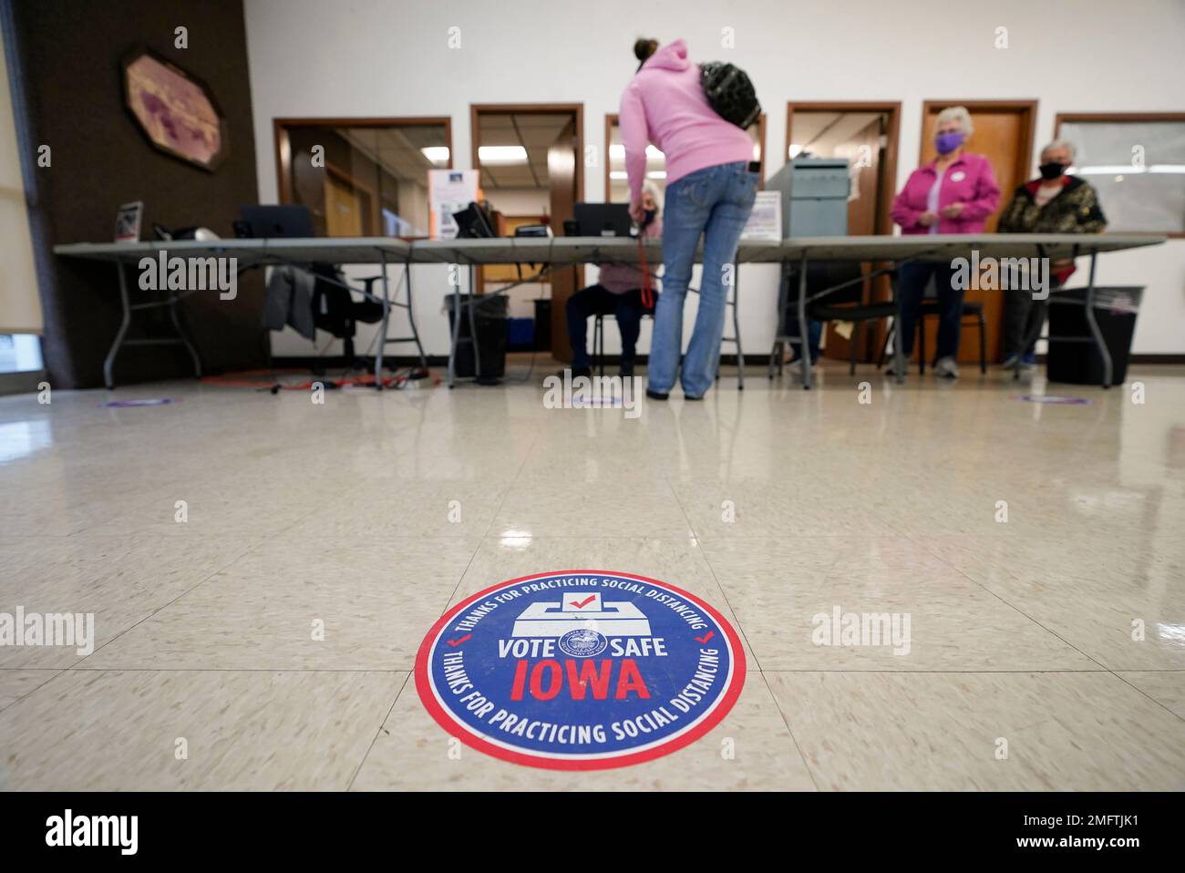 A local resident gets her ballot during early voting, Tuesday, Oct. 20 ...