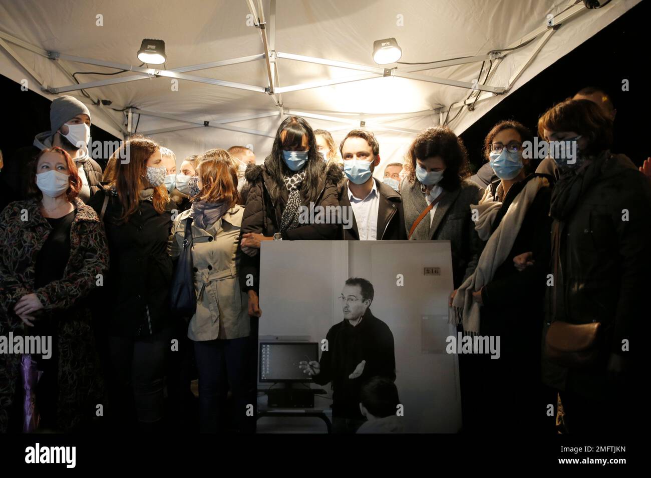 People hold a photo of the history teacher Samuel Paty , who was ...