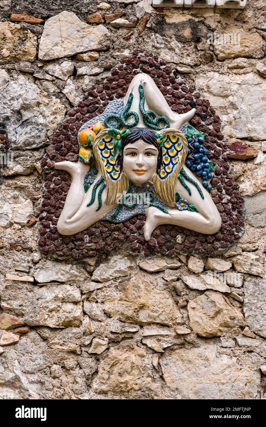 Stone wall in one of the alleys of the tourist destination of Taormina ...