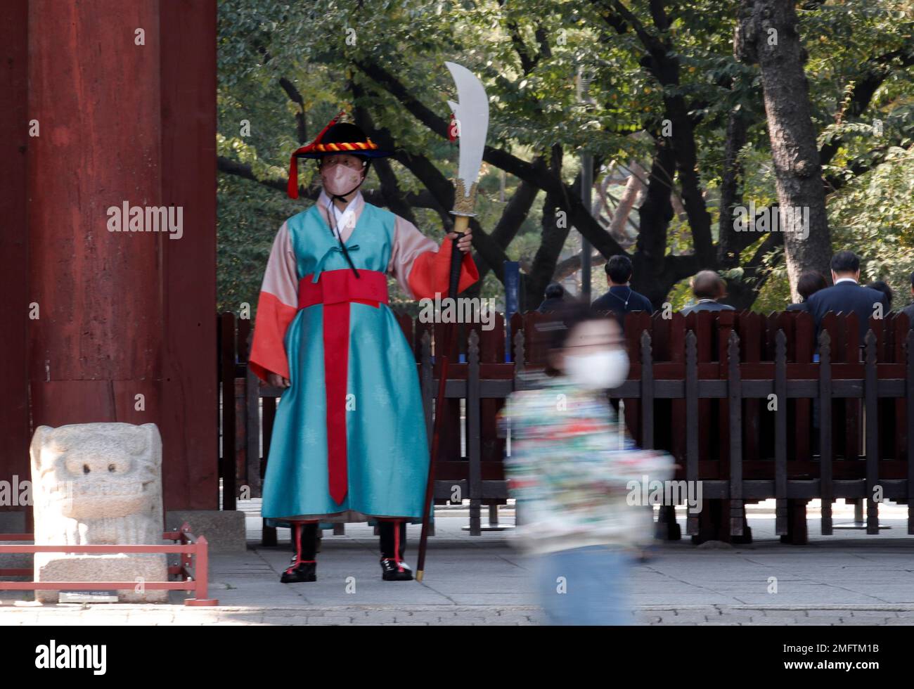 A performer wearing traditional guard uniforms and protective face ...