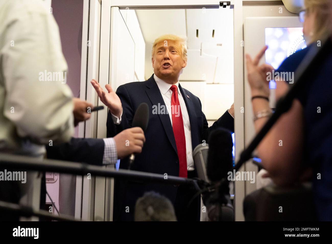 President Donald Trump speaks with reporters while in flight on Air ...