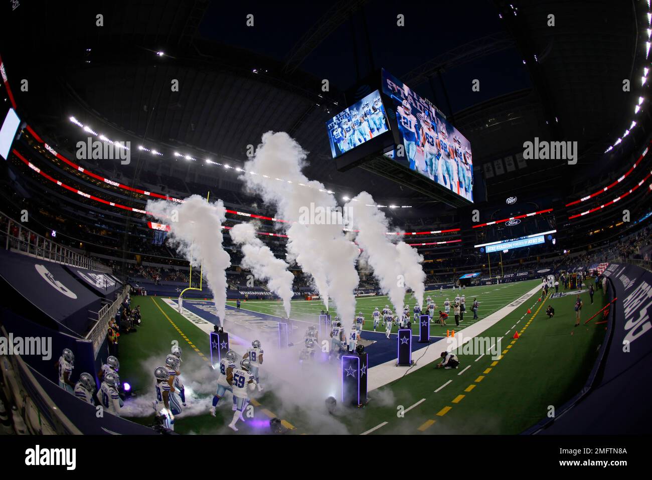 The Dallas Cowboys jog onto the field for the first half of an NFL ...