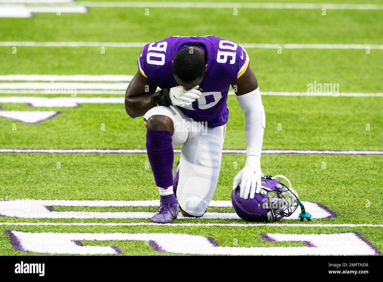 Minnesota Vikings defensive end Jalyn Holmes (90) prays before the ...