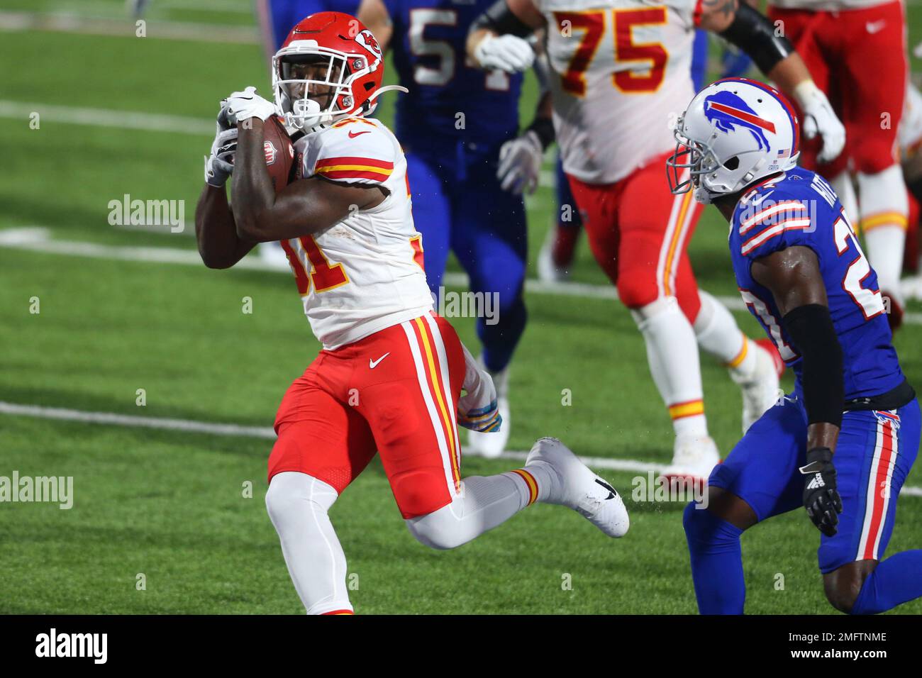 Kansas City Chiefs' Darrel Williams, left, runs the ball for a ...