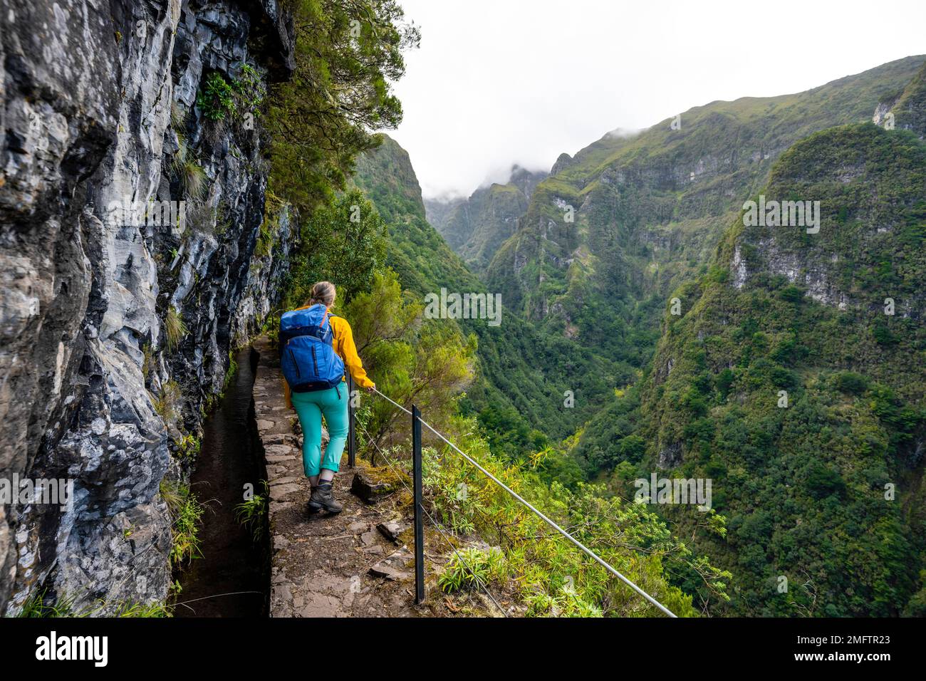Hiker on a Levada, PR9 Levada do Caldeirao Verde, Madeira, Portugal ...
