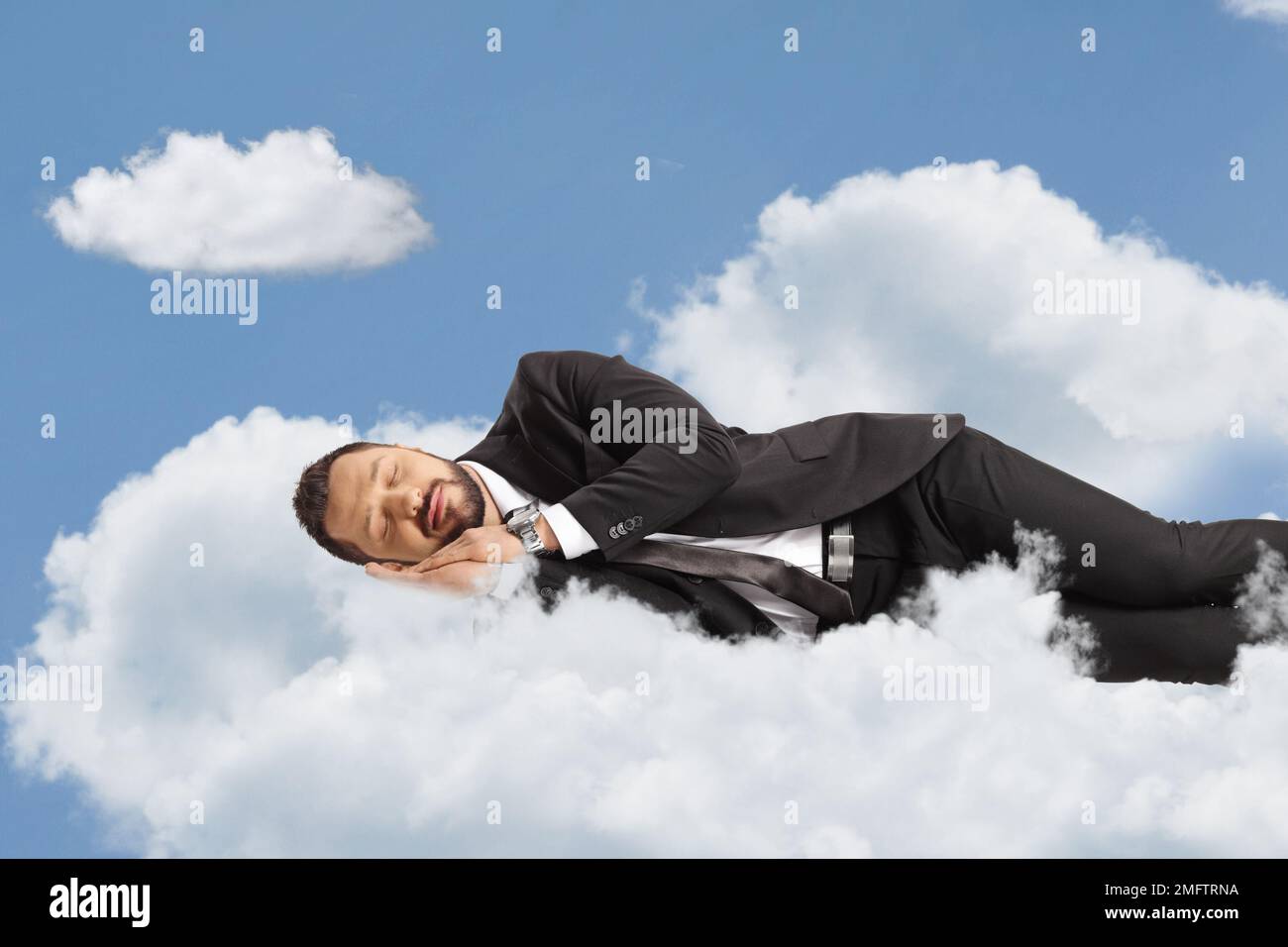 Businessman sleeping over clouds up in the sky Stock Photo - Alamy