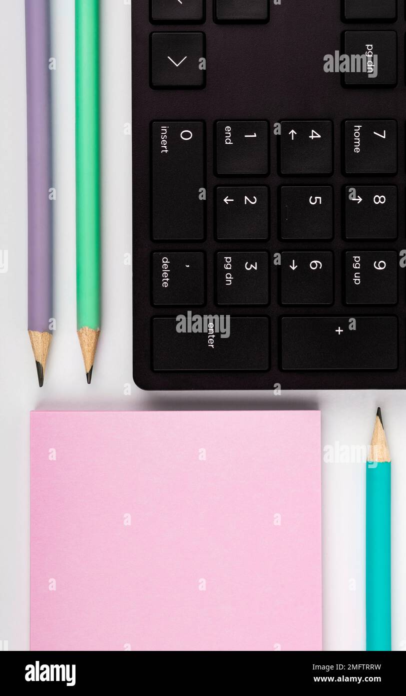 Colored paper with important message lying desk near keyboard. Main ...