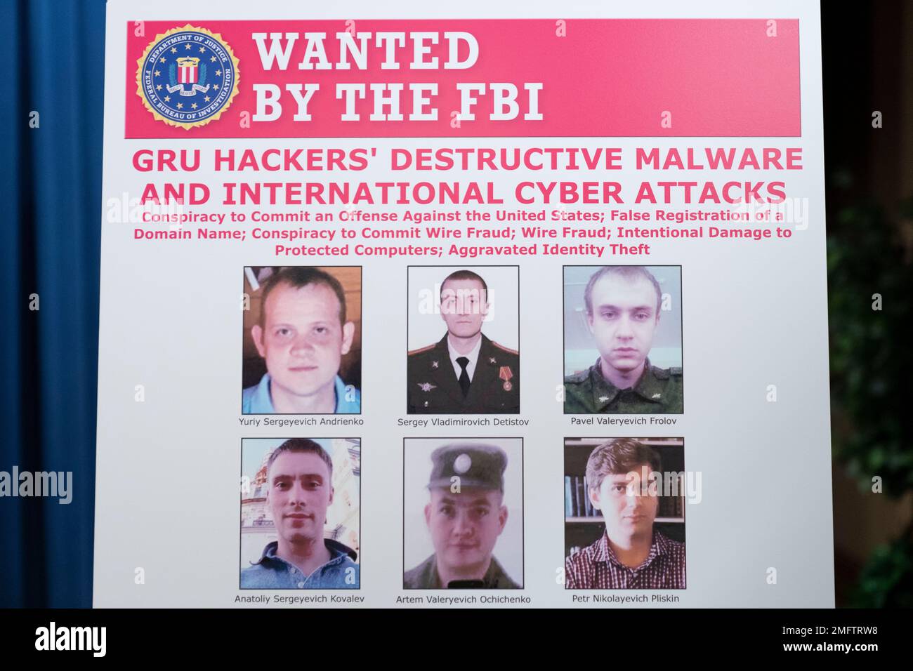 A poster showing six wanted Russian military intelligence officers is ...