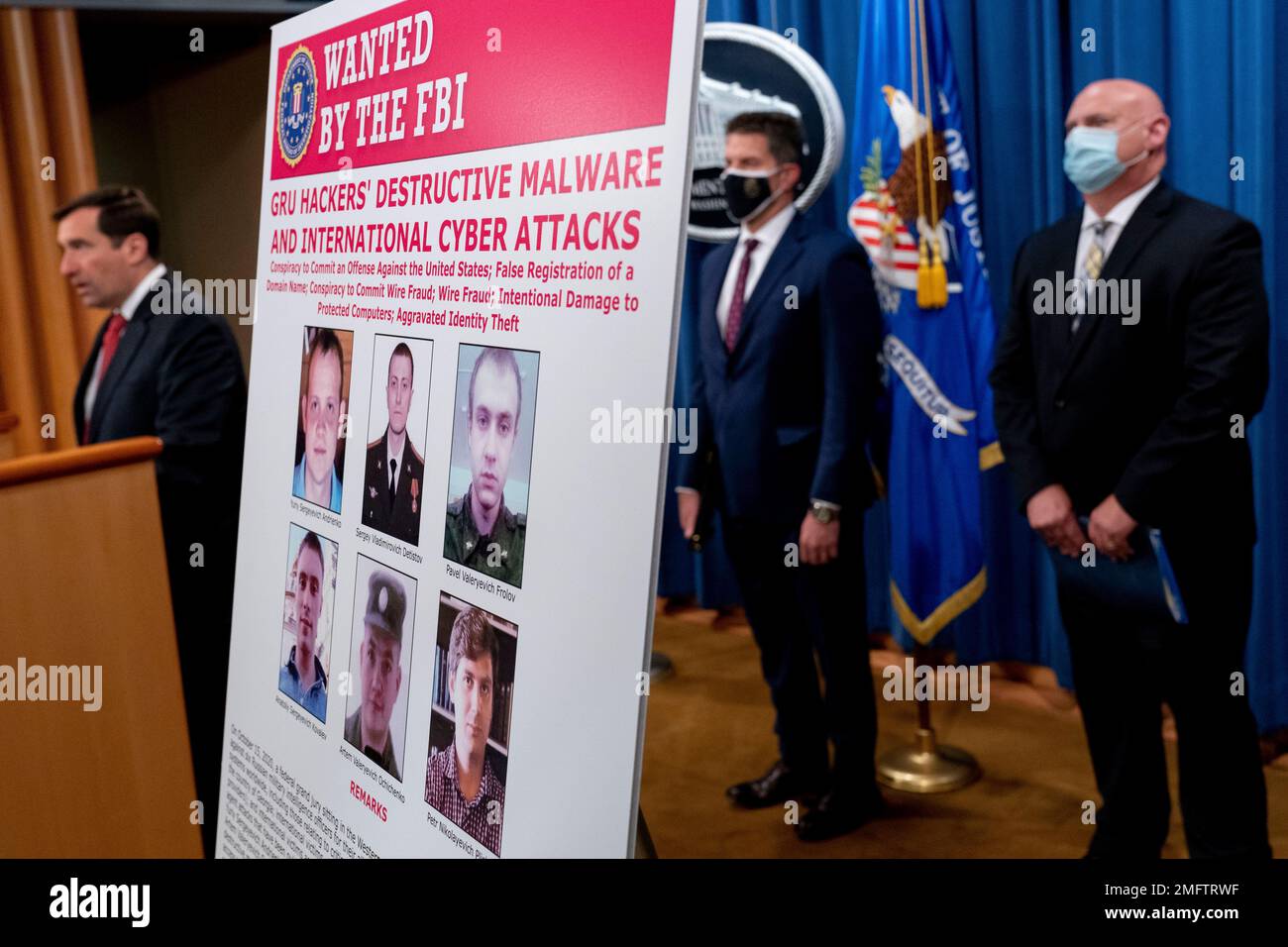 A poster showing six wanted Russian military intelligence officers is ...