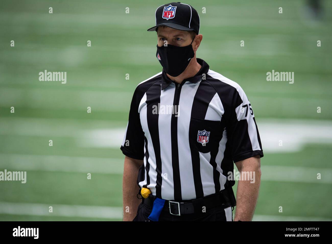 NFL umpire Alan Eck (76) walks on the field before an NFL football game ...