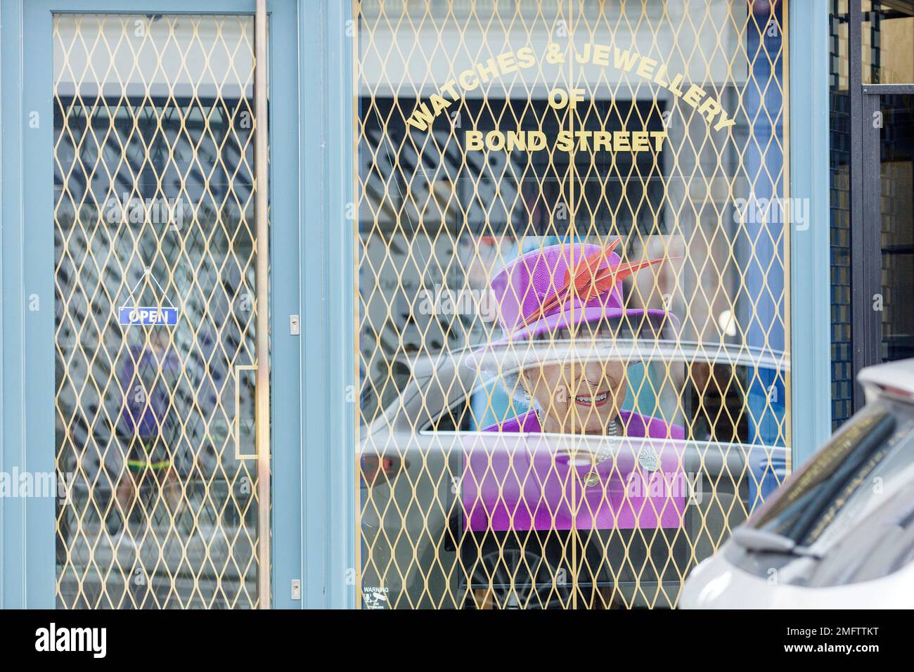 A portrait of Queen Elizabeth II is displayed in a shop window in ...
