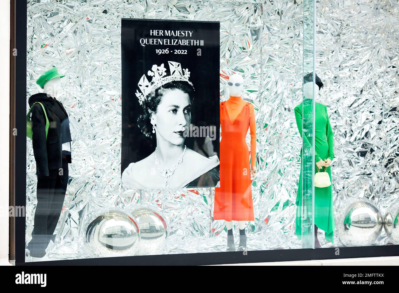 A portrait of Queen Elizabeth II is displayed in a shop window in ...