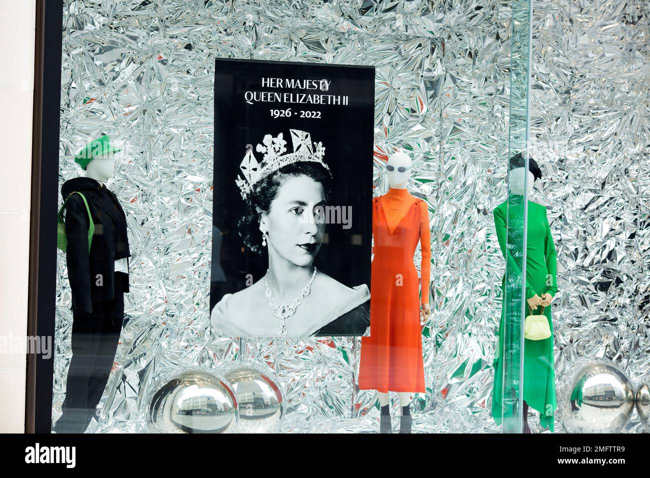 A portrait of Queen Elizabeth II is displayed in a shop window in ...