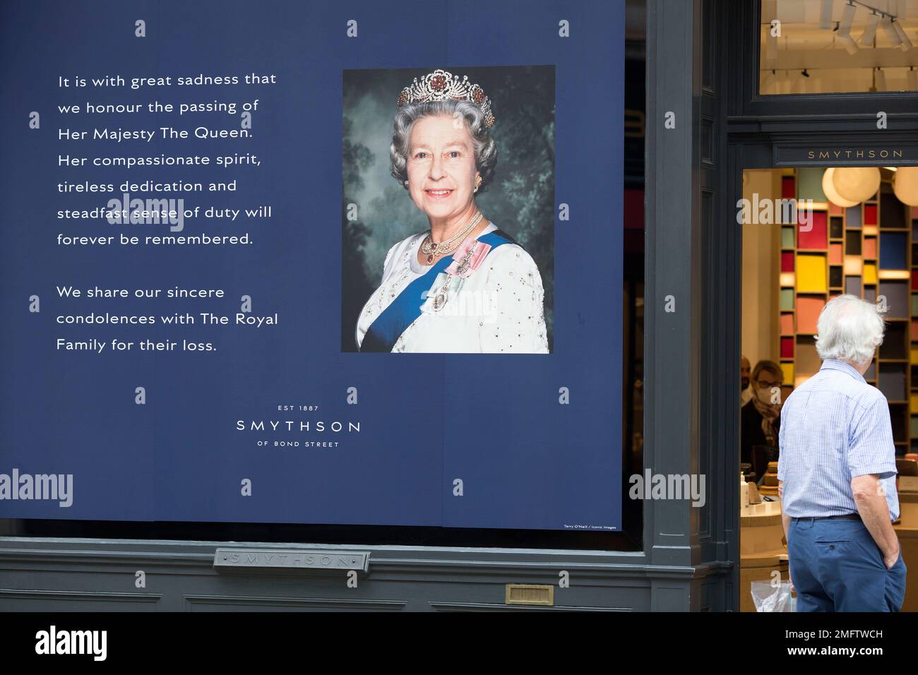 A portrait of Queen Elizabeth II is displayed in a shop window in ...