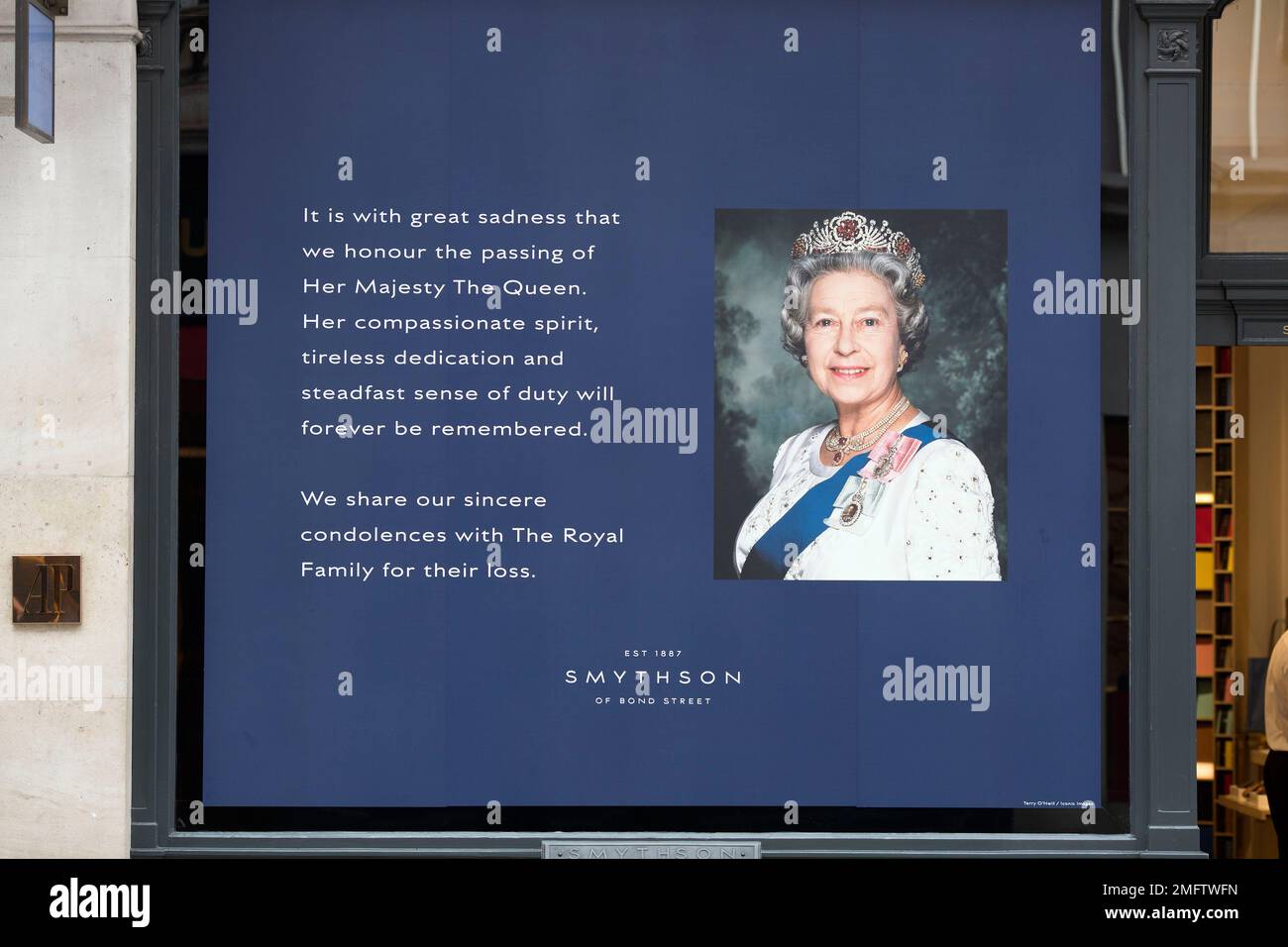 A portrait of Queen Elizabeth II is displayed in a shop window in ...