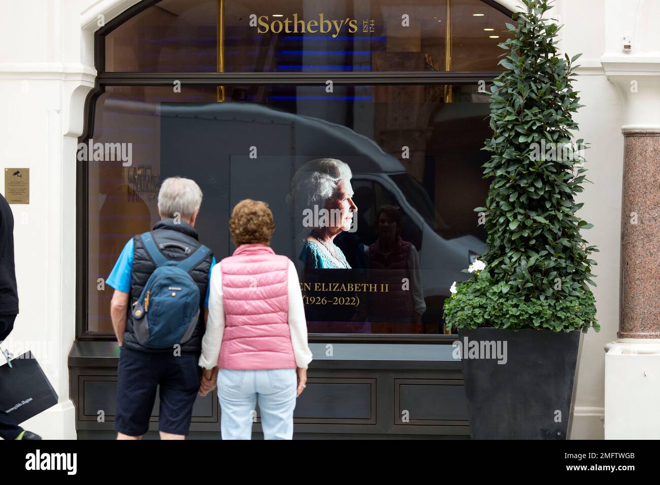 A portrait of Queen Elizabeth II is displayed in a shop window in ...
