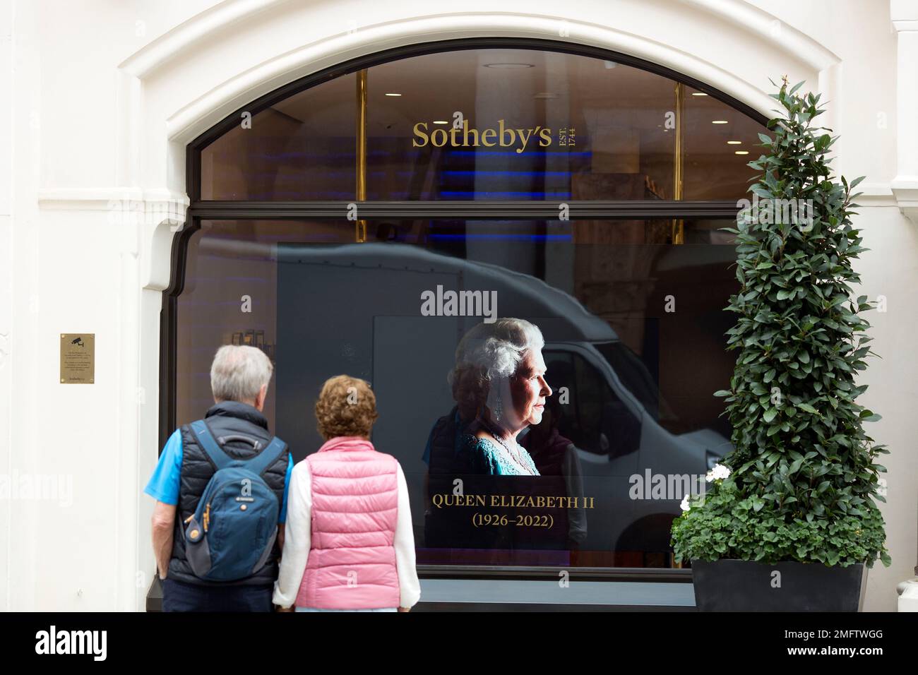 A portrait of Queen Elizabeth II is displayed in a shop window in ...