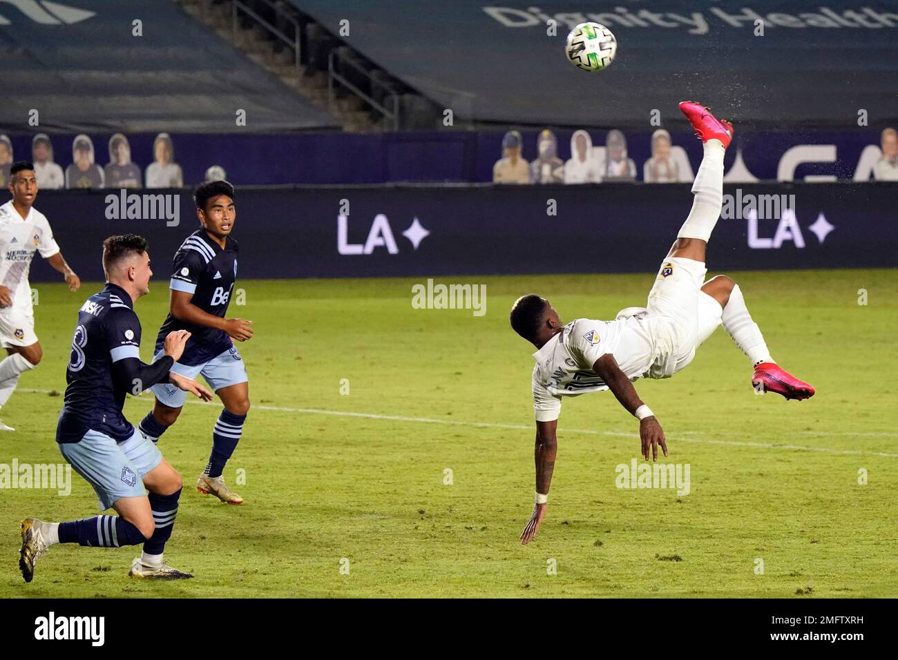Los Angeles Galaxy's Yony Gonzalez, right, takes a shot on goal with a ...