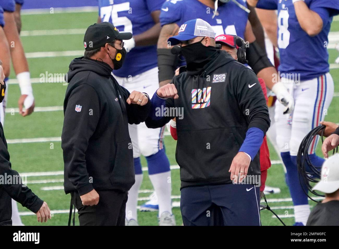 Washington Football Team's Ron Rivera, left, talks to New York Giants ...