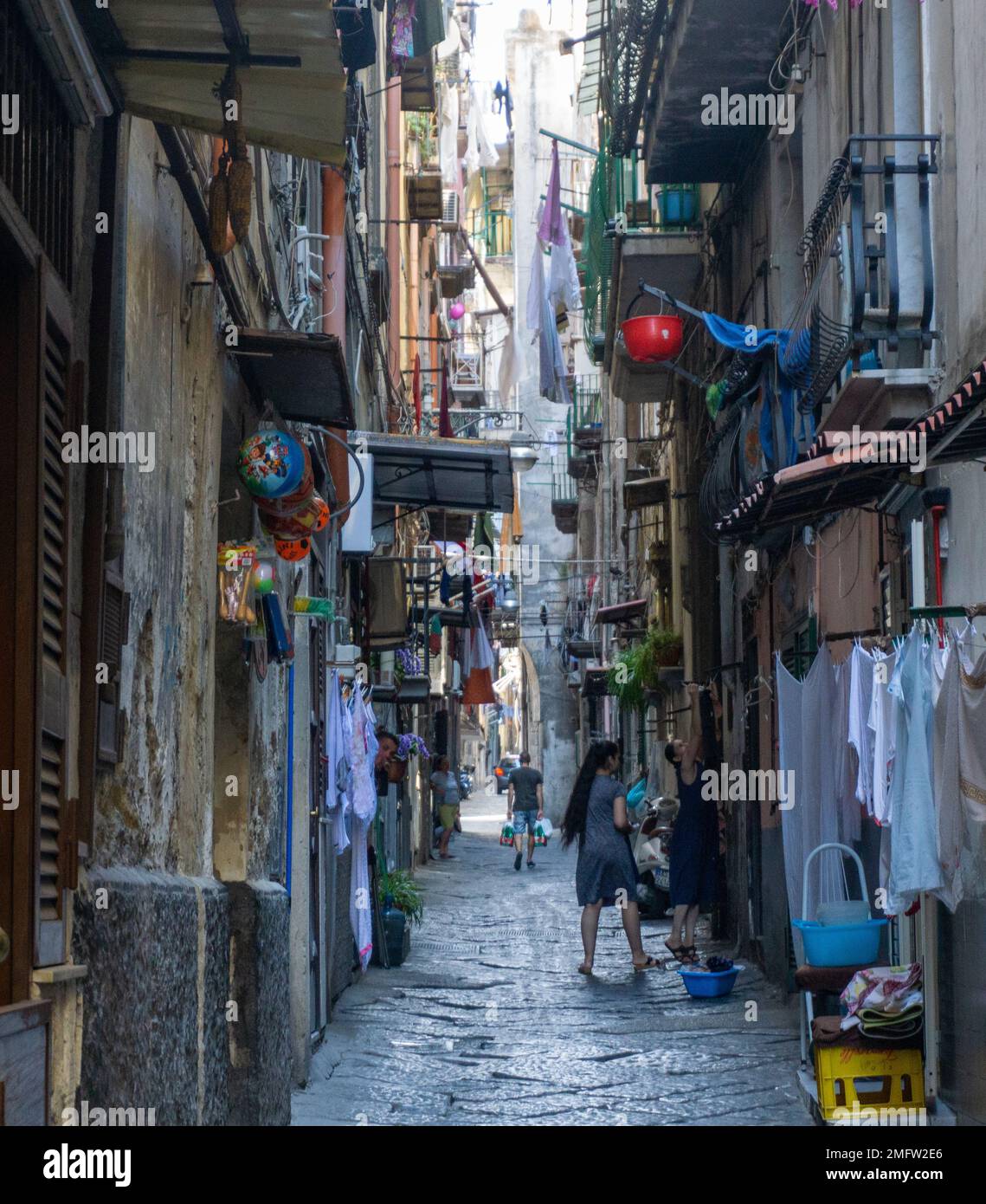 Man walks down a crowded neighborhood street in Naples, Italy Stock ... Man walks down a crowded neighborhood street in Naples, Italy Stock ...