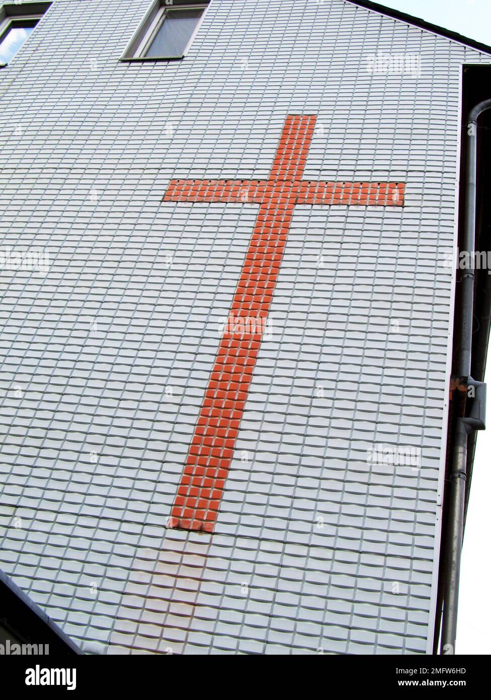 Cross on house facade Stock Photo - Alamy