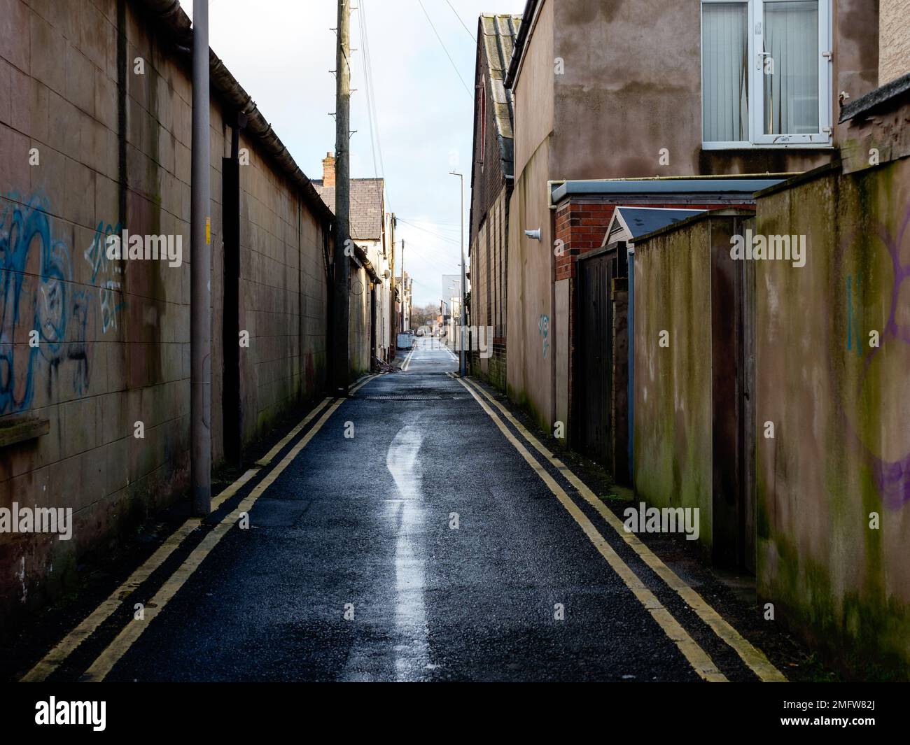 Narrow back alley in the scruffy back streets of Blackpool Lancashire ...