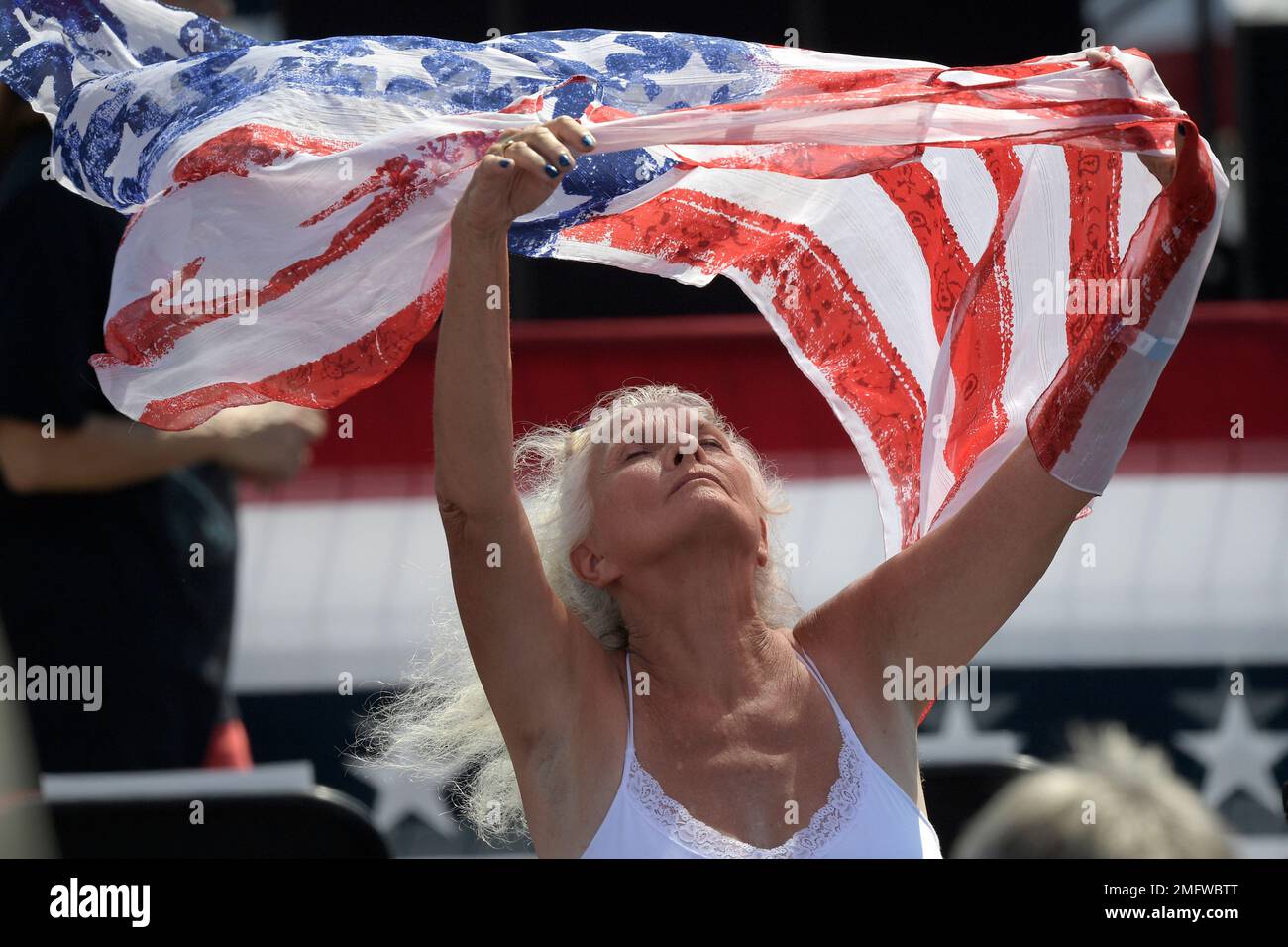 A President Donald Trump supporter keeps cool with a United States flag ...
