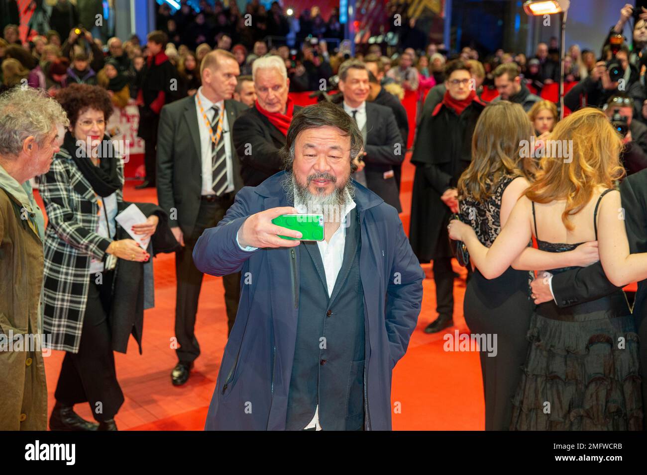 Chinese artist Ai Weiwei takes a photo with his smartphone as he arrives on the red carpet for ...