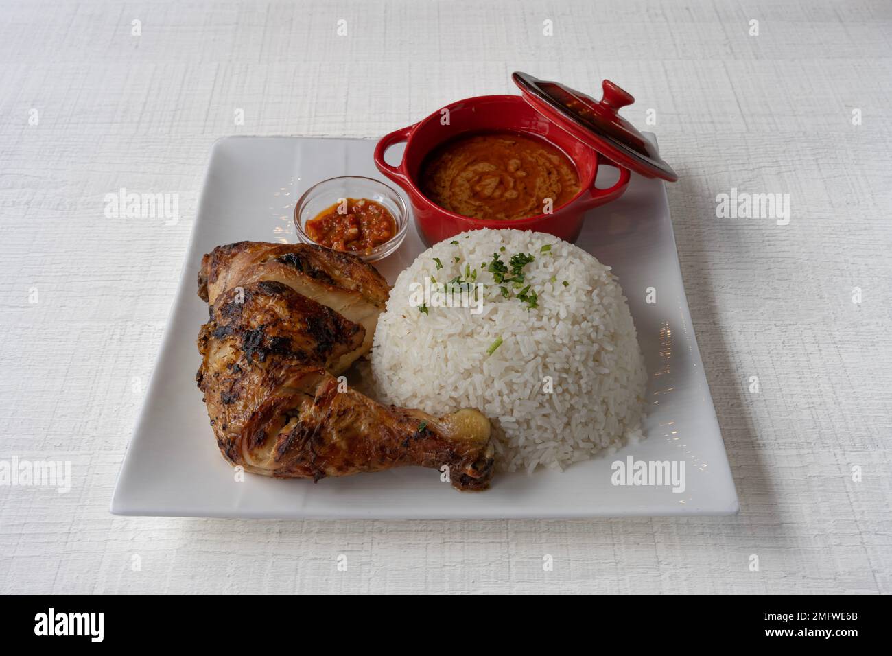 African dishe culinary Still Life. Chicken mafe with Grilled chicken ...