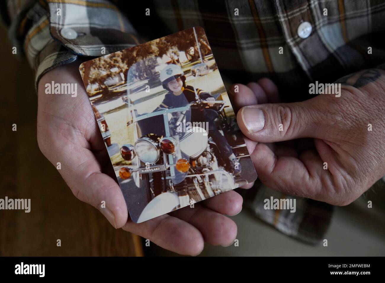 Los Angeles Police Department Officer Bryce Verna holds a photograph of ...