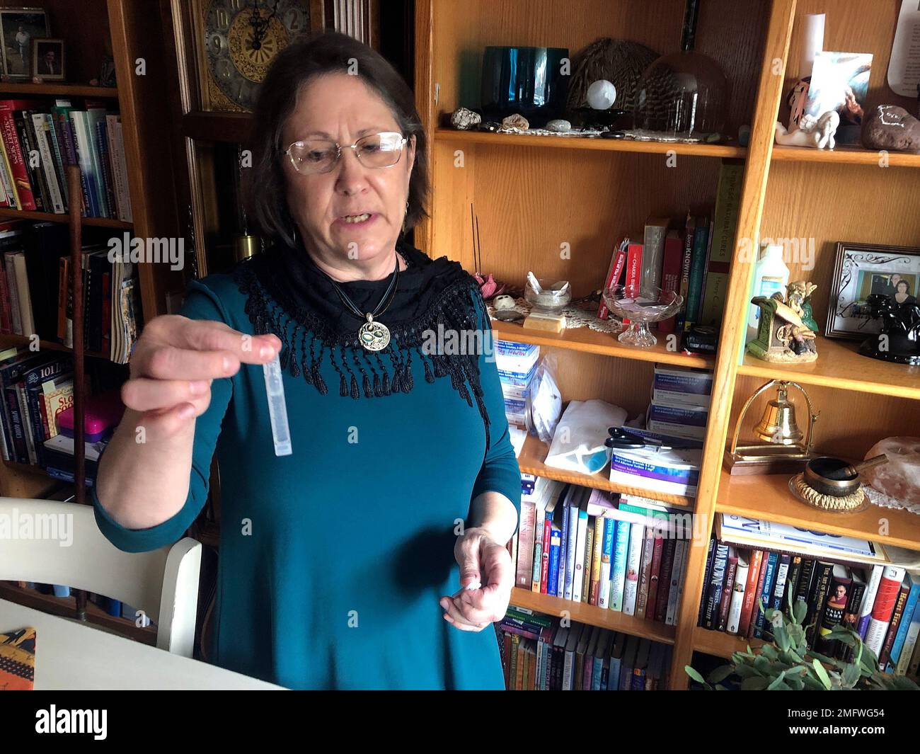 Barbara Trout, who has an asthma disorder, holds a vial of inhalation ...