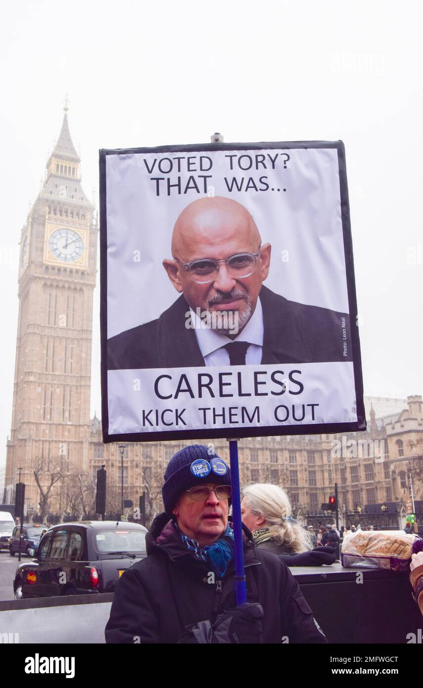 London, UK. 25th Jan, 2023. A protester holds an anti-Tory placard with ...