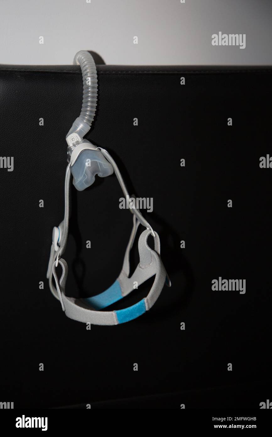 Sleeping Apnea CPAP mask Machine in bed room in home patient Stock ...