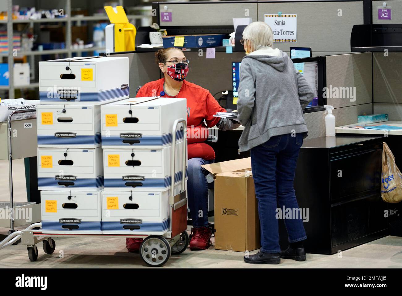 Harris County election workers handle mail-in ballots at election ...