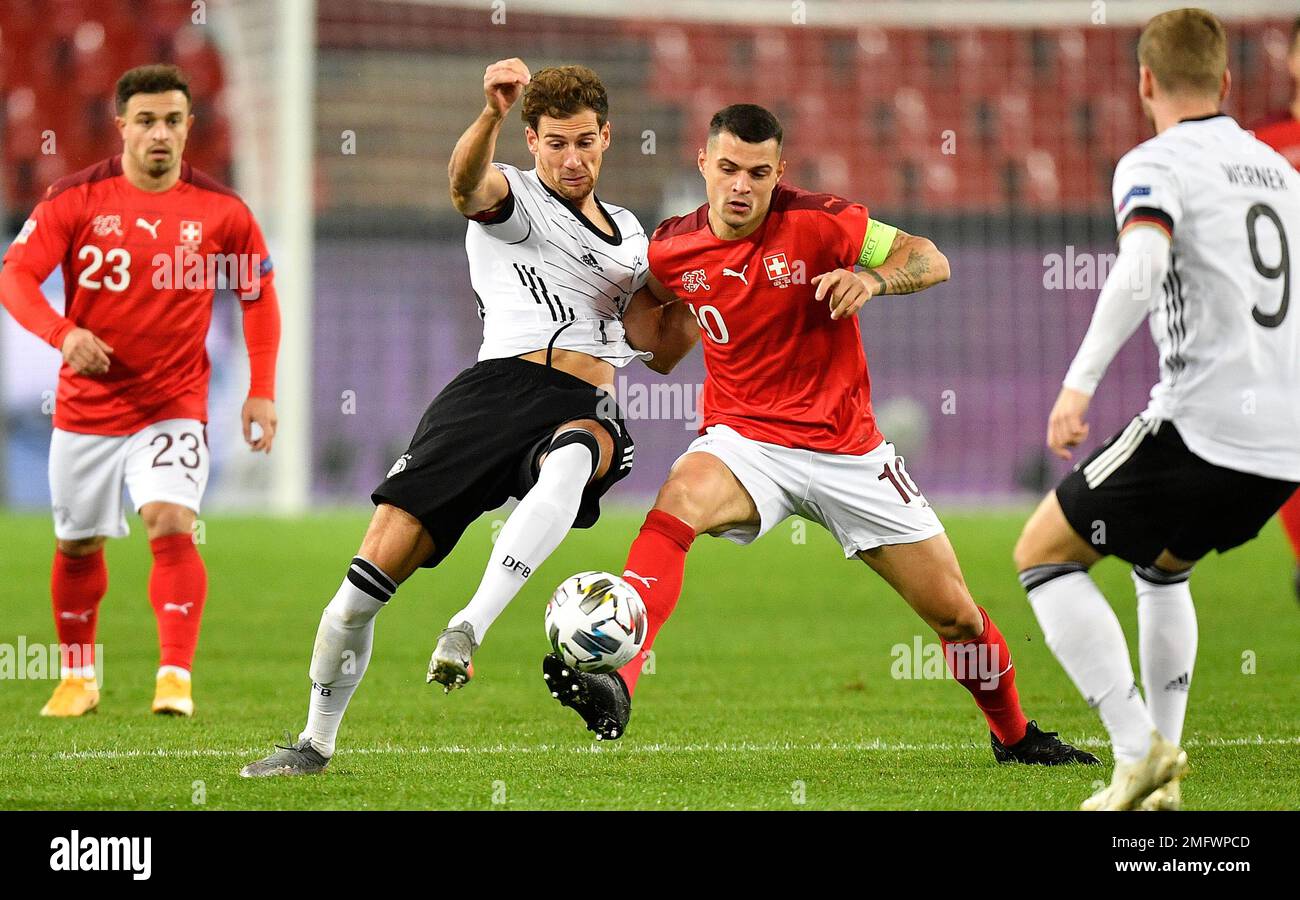 Germany's Leon Goretzka, left, and Switzerland's Granit Xhaka challenge ...