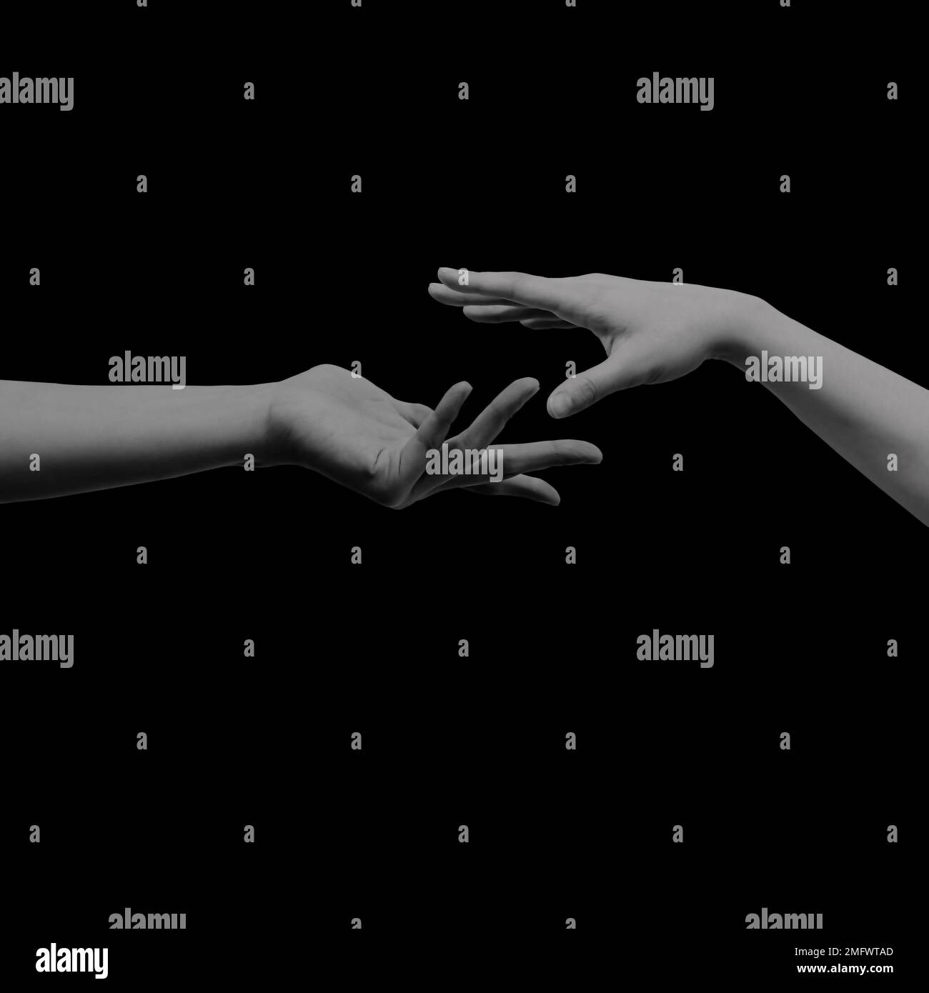 A scenic shot of hands trying to reach each other isolated on the black ...