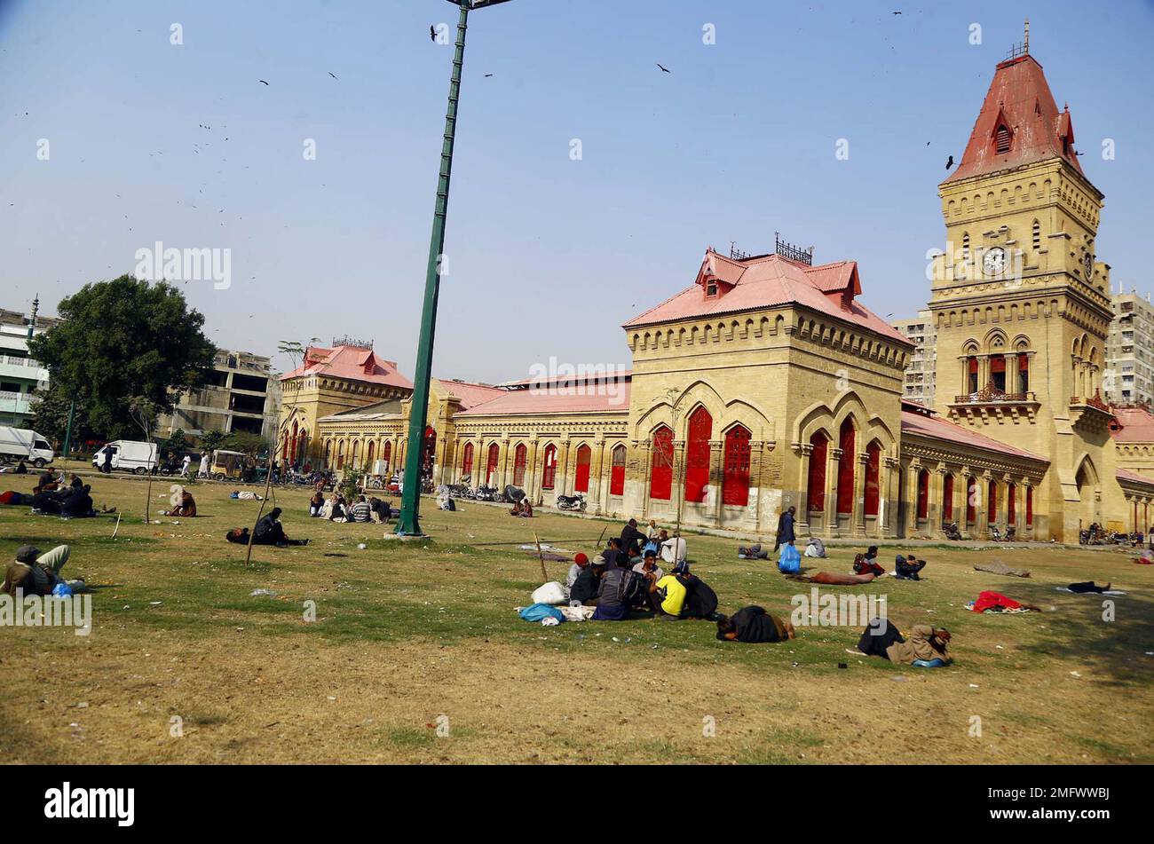 People warm themselves from scorching sun during winter season on below ...