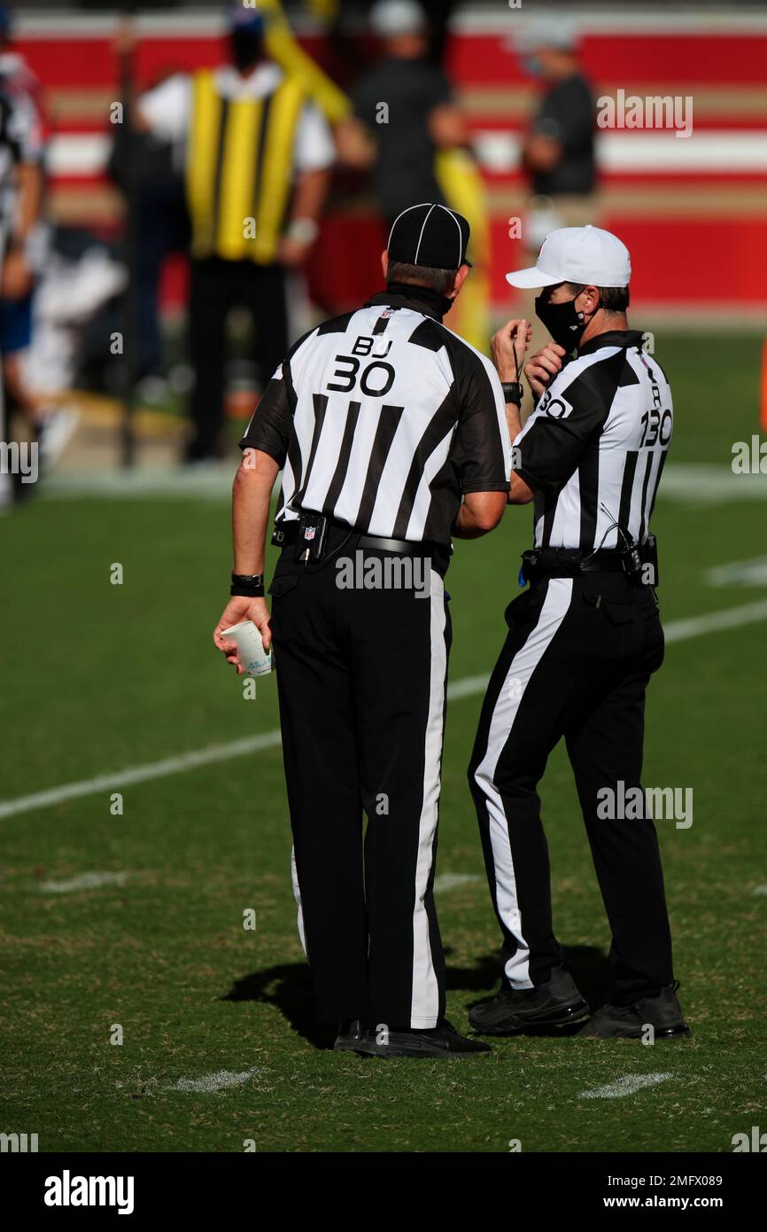 Referee Land Clark (130)and back judge Todd Prukop (30) in action ...