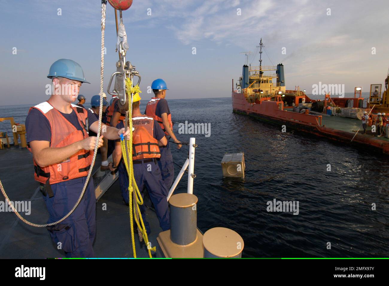 Boarding Loading Operations - 26-HK-69-8. Coast Guardsmen observing ...