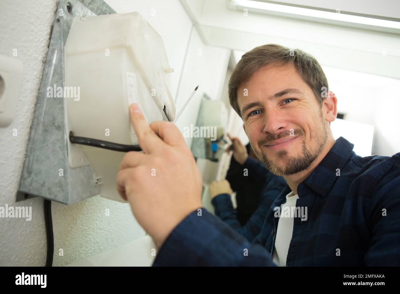 man during installation of hand-dryer Stock Photo - Alamy