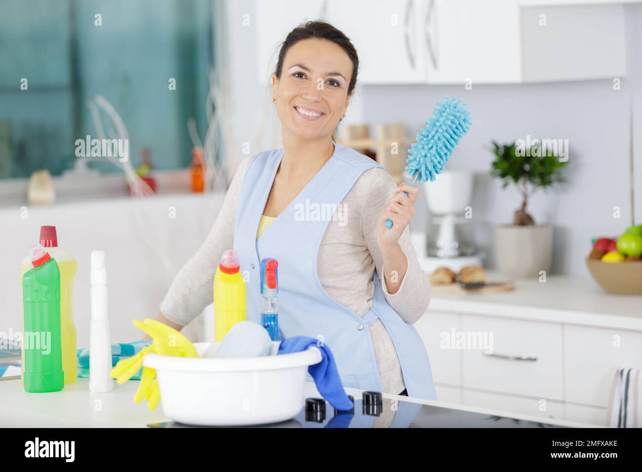 female cleaner holding a bucket with cleaning supplies Stock Photo - Alamy