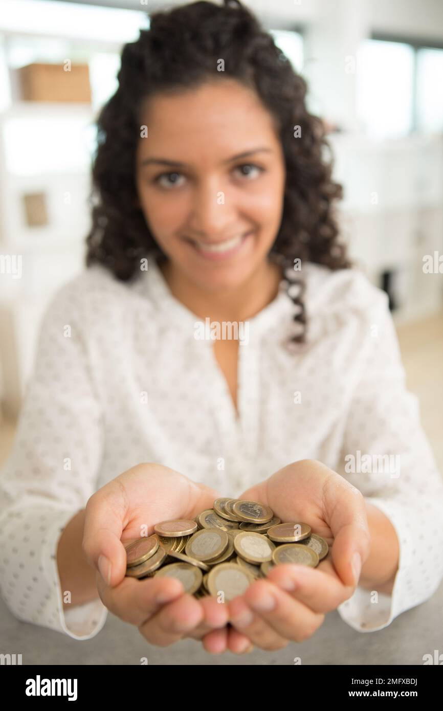 woman holding coins in hand Stock Photo - Alamy