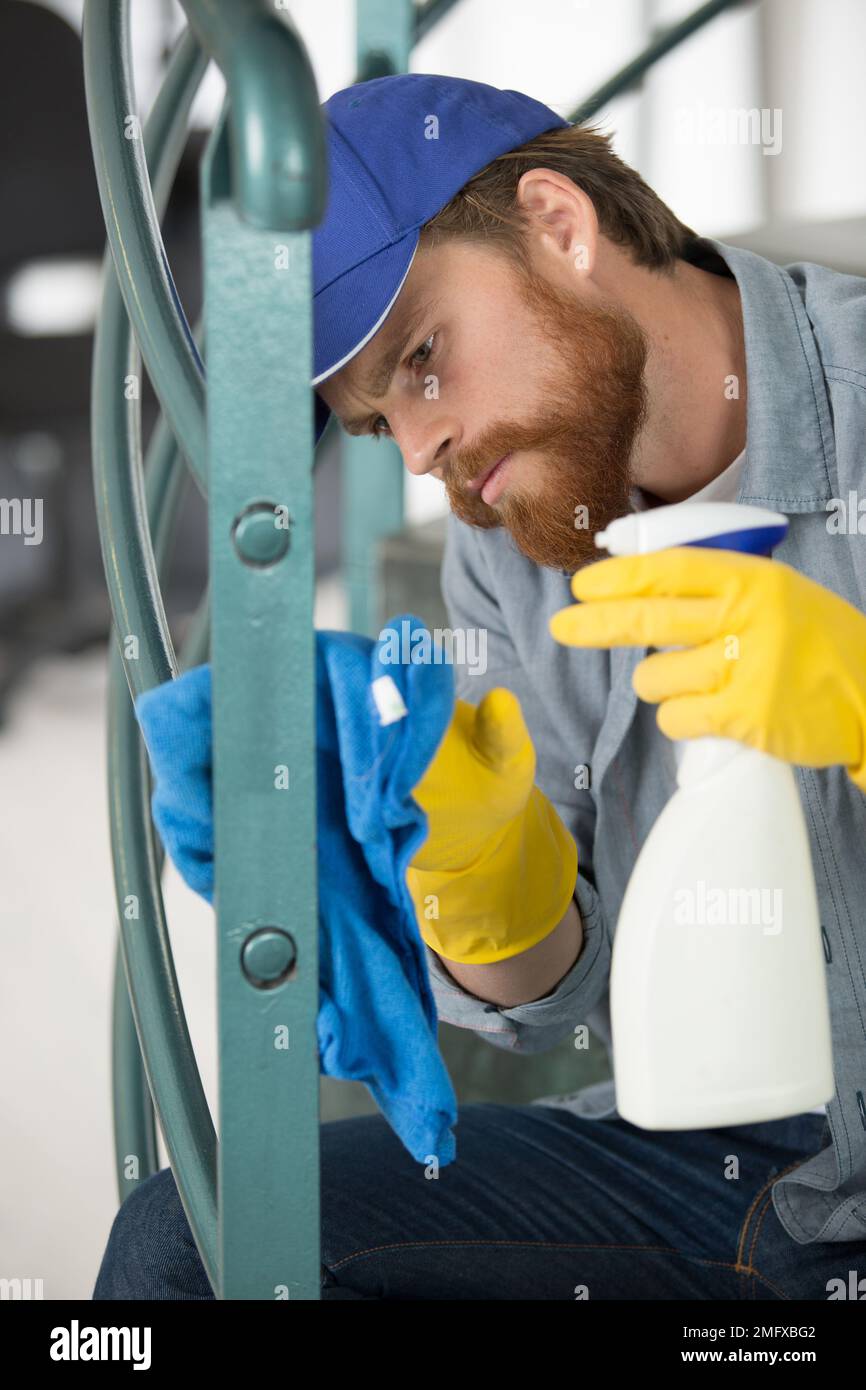 male cleaner uses a spray Stock Photo - Alamy