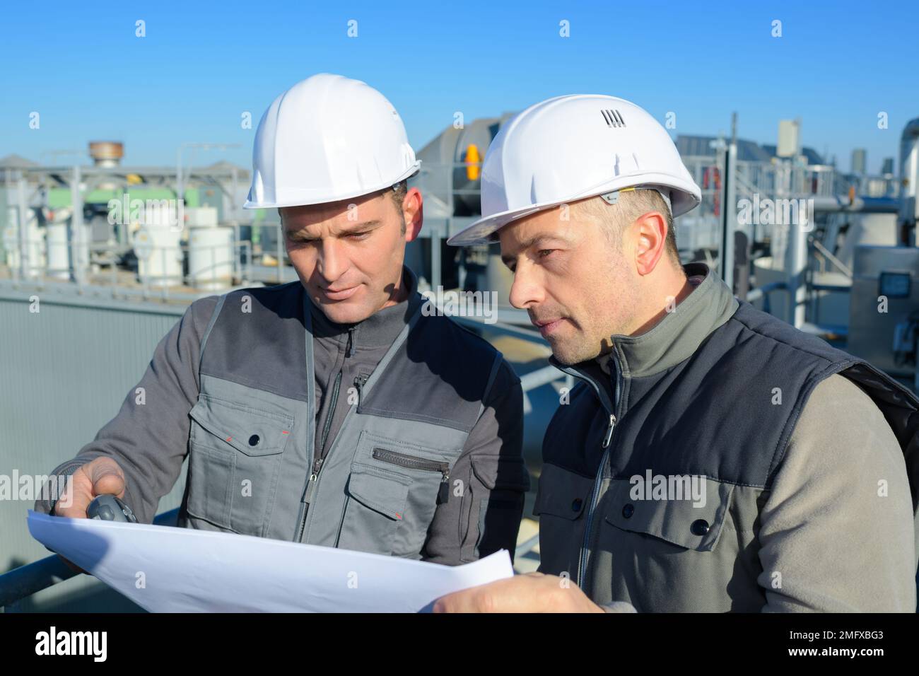 project site engineers studying the blueprint Stock Photo - Alamy