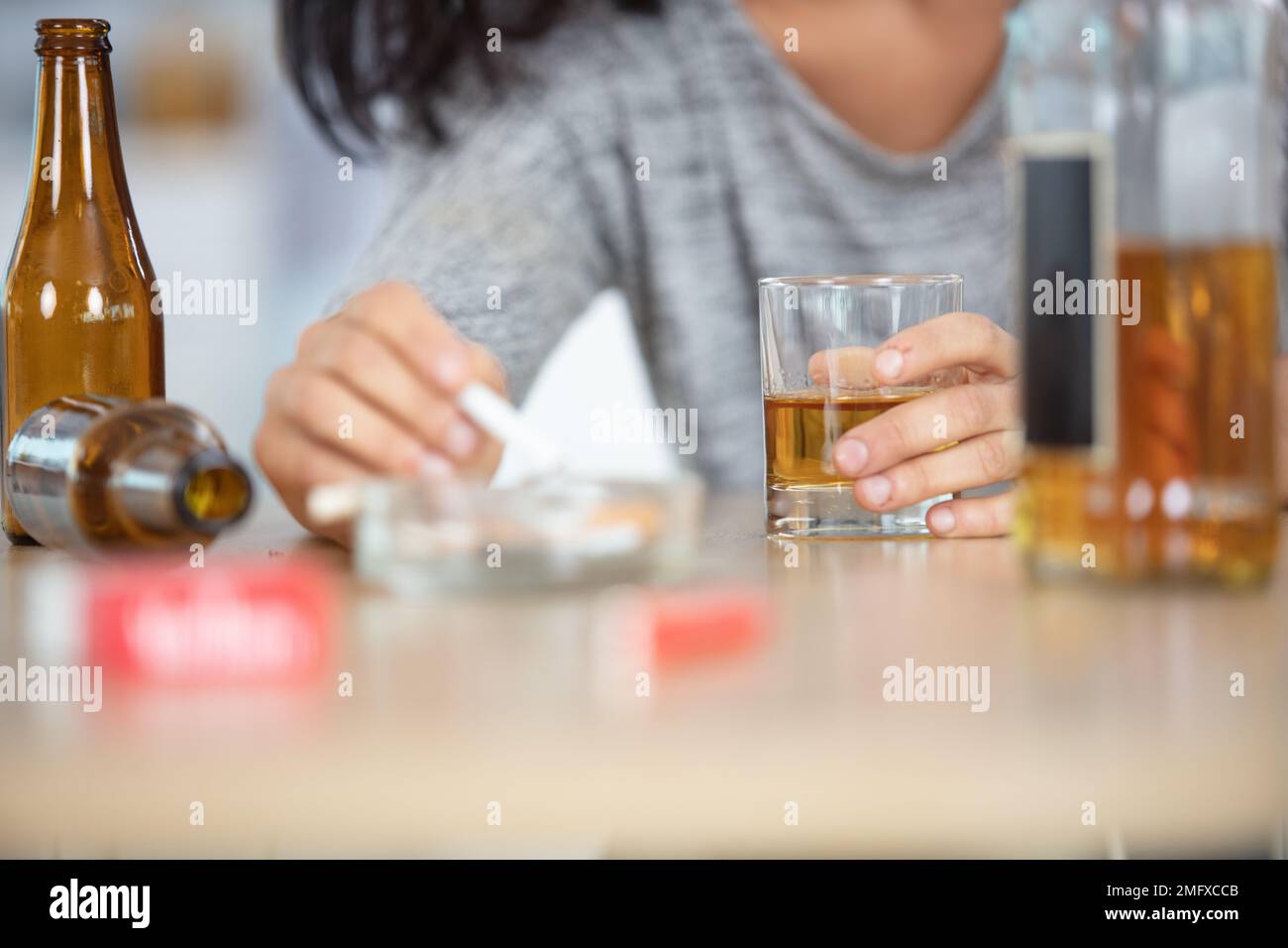 woman hands holding a cigarette and drinking alcohol Stock Photo - Alamy