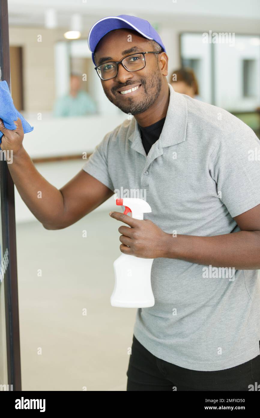 Young man washing windows hi-res stock photography and images - Alamy