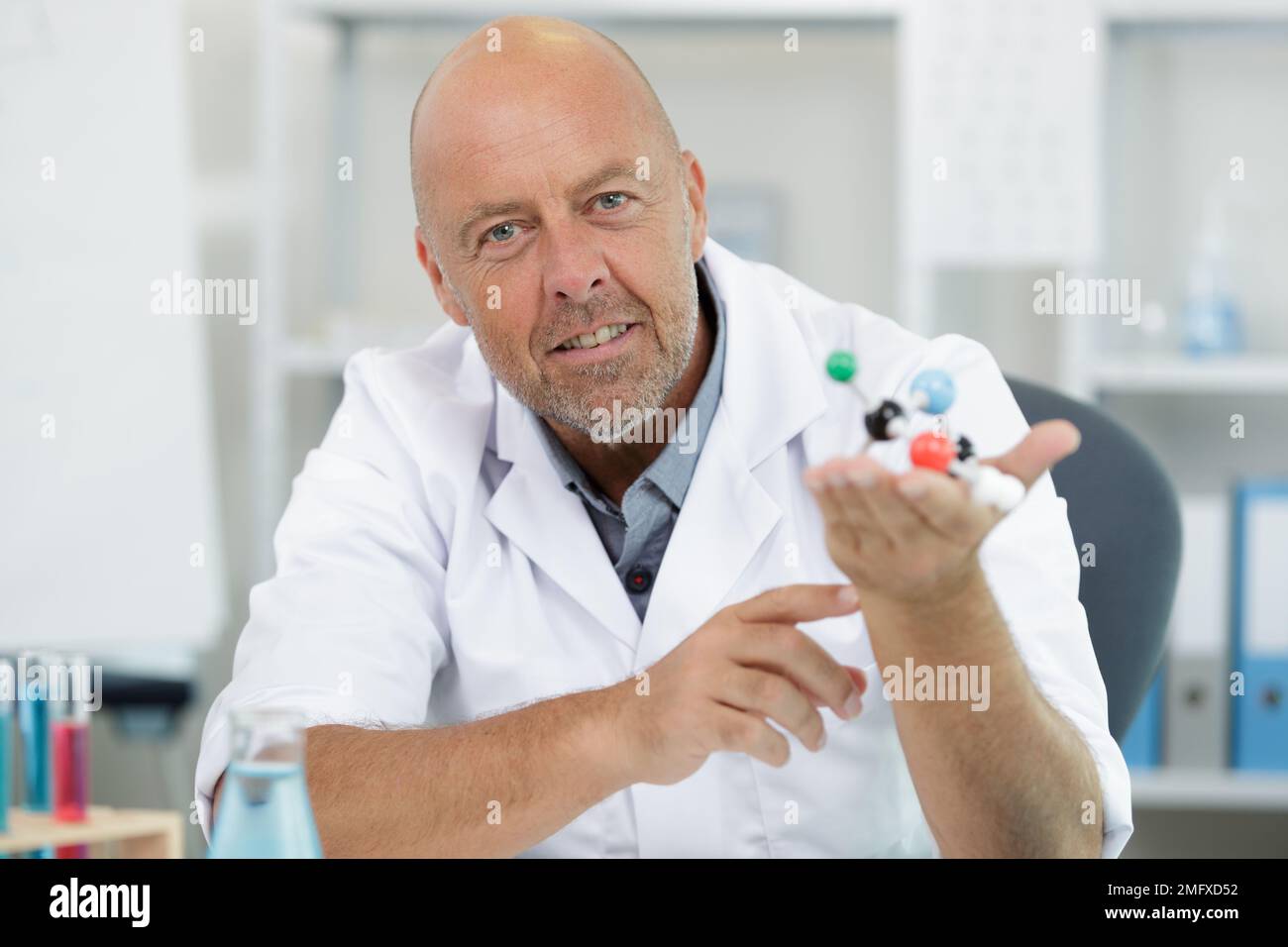 scientist man showing molecule model Stock Photo - Alamy